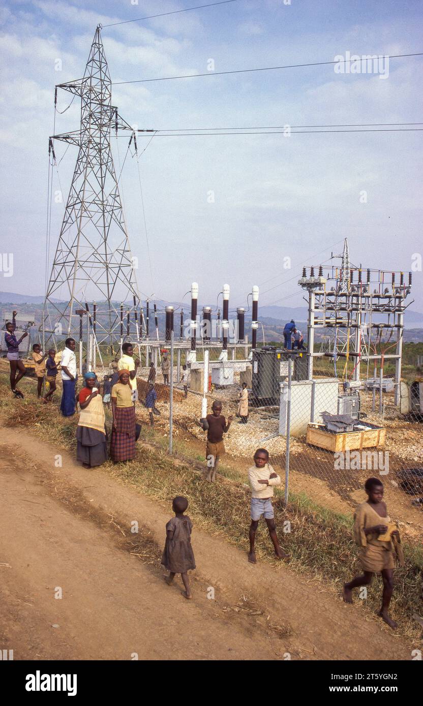 Rwanda, Kigali region; people watching a fenced electricity station ...