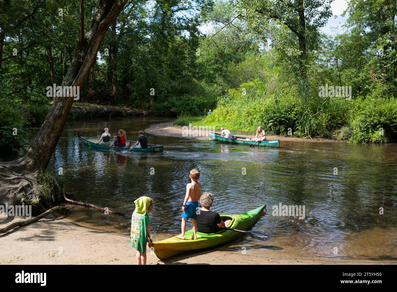 People passing in canoes at river Dommel, at nature reserve "Malpie" in ...