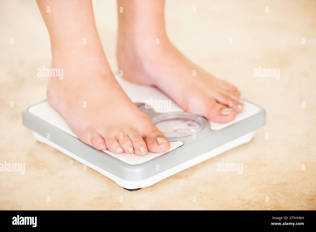 Woman, weight loss and feet on scale for measurement, goal and control ...