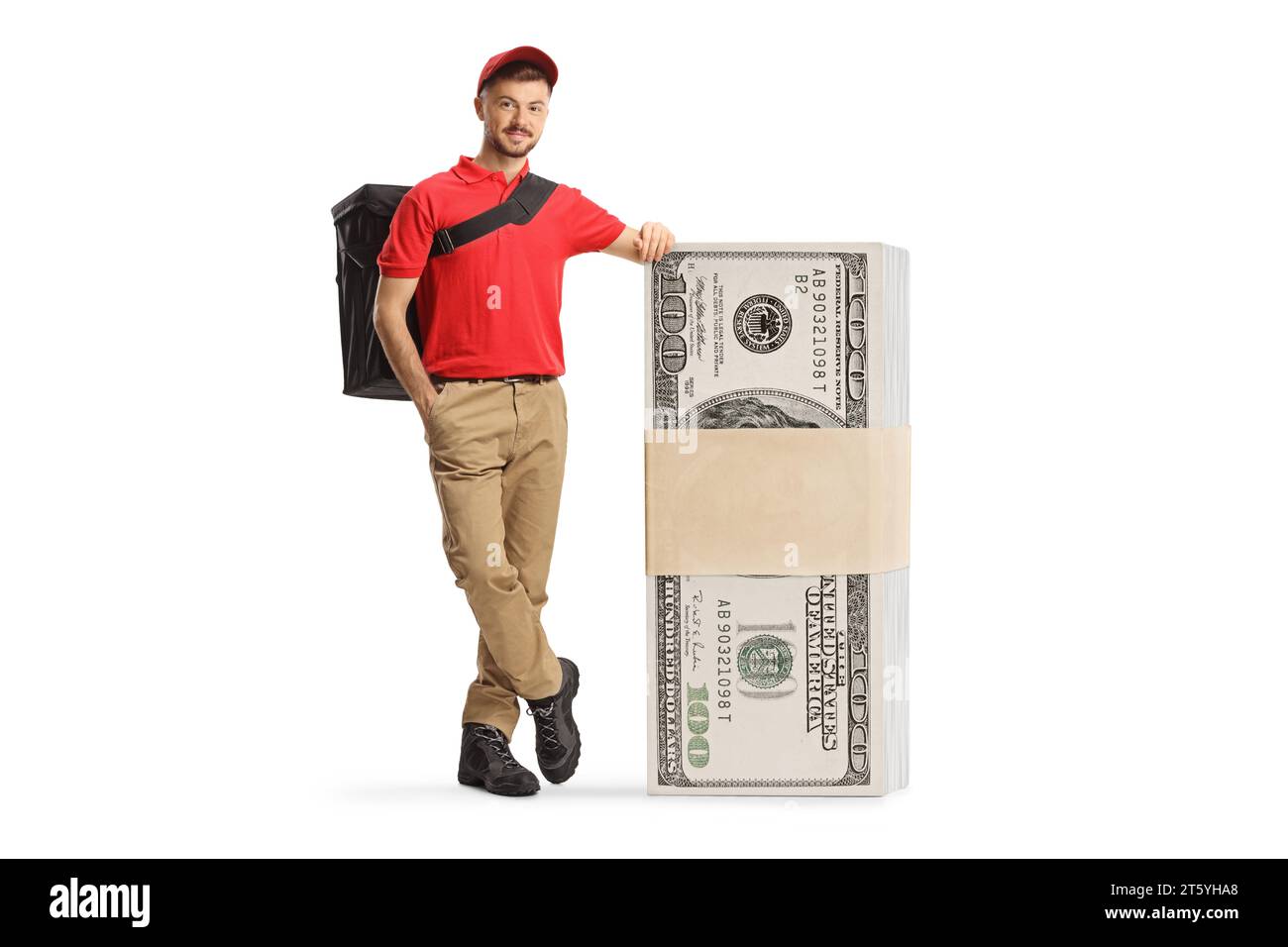 Delivery man leaning on a stack of money isolated on white background ...