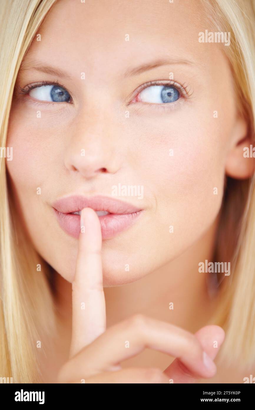 Woman, secret and finger on lips with thinking for sign, choice or deal ...