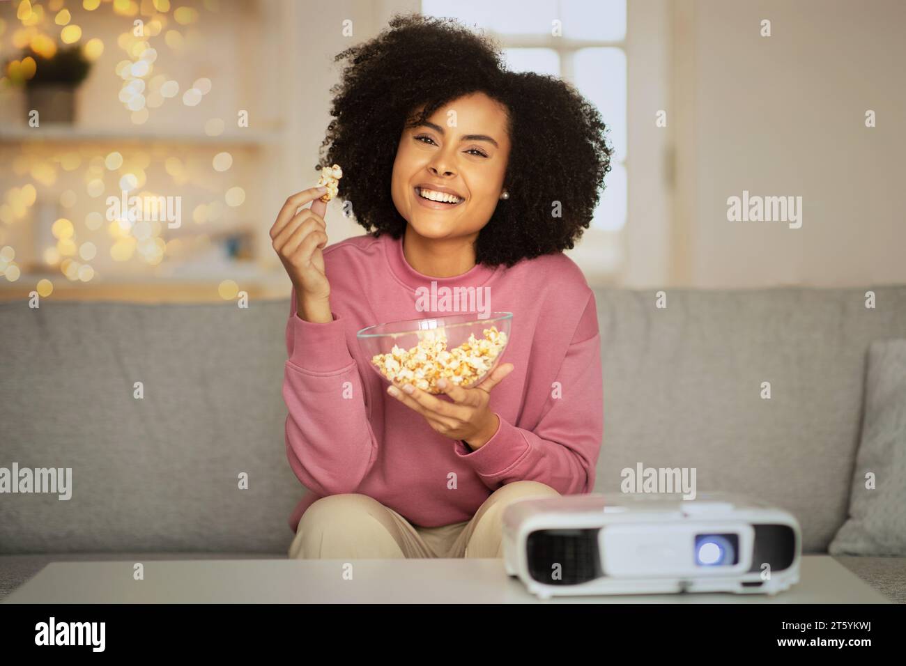 African american woman watches tv hi-res stock photography and images ...