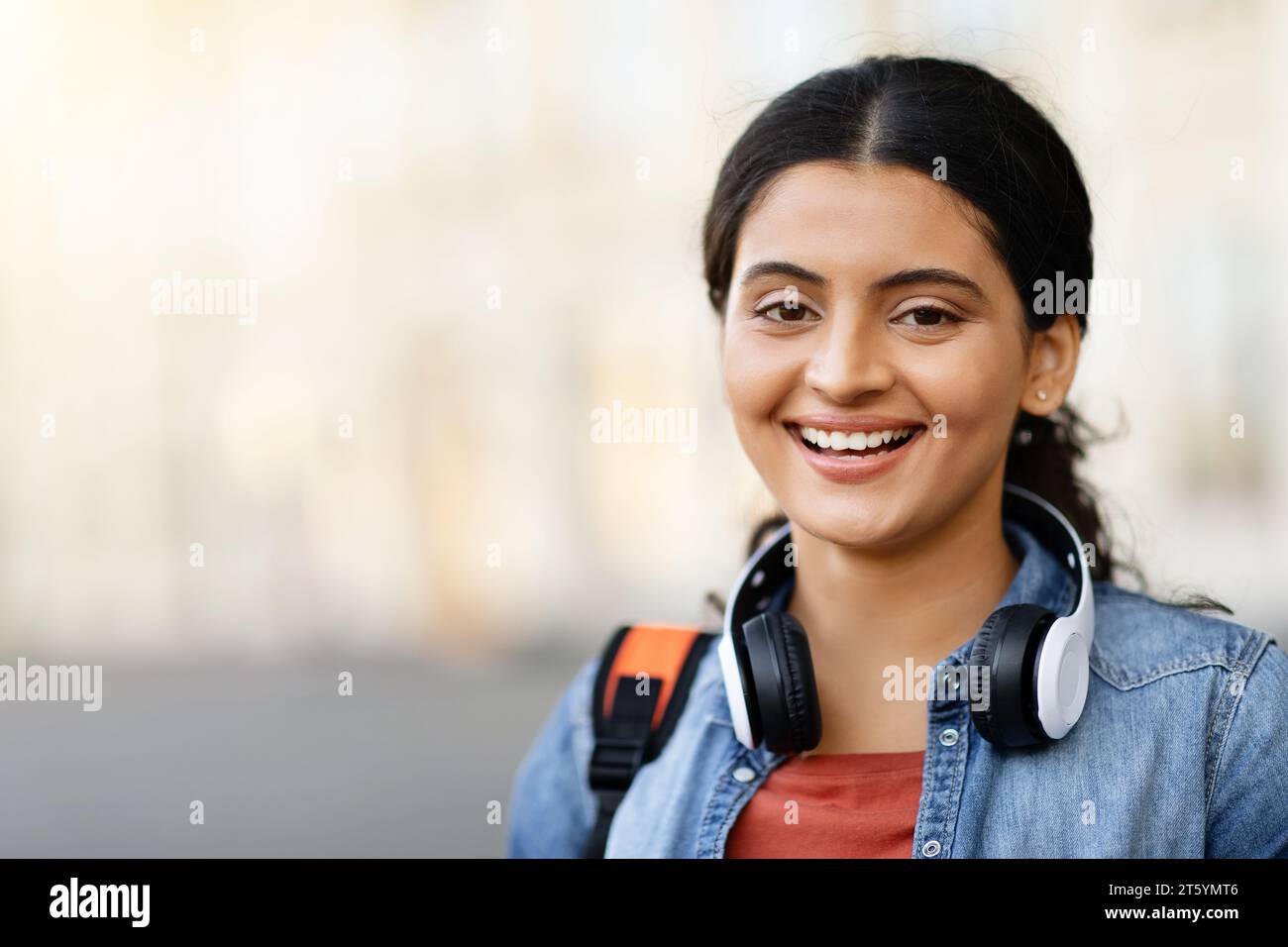 Smiling hindu lady student with backpack and wireless headphones Stock ...