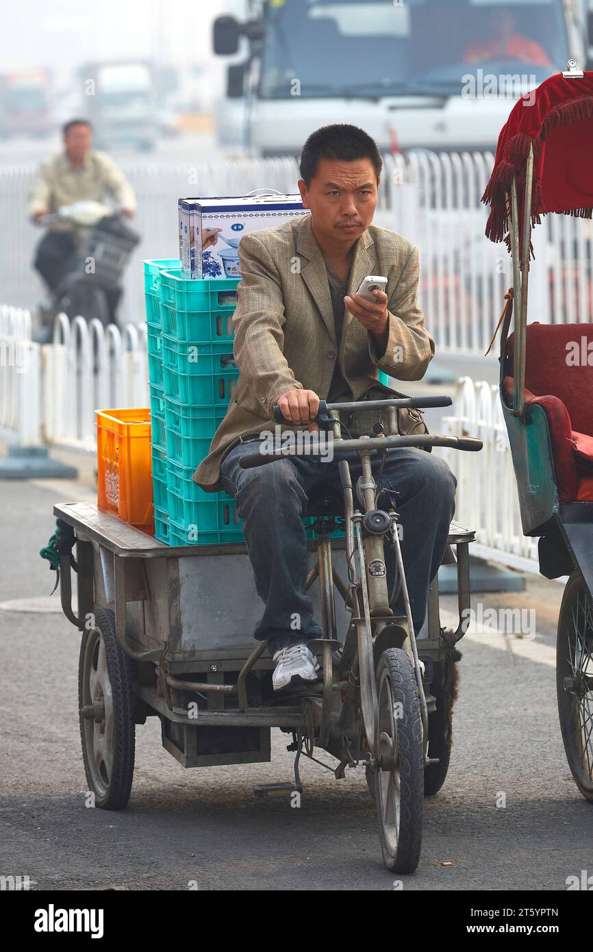 A Chinese Man Riding A Cycle Rickshaw (Three Wheeler) During The ...