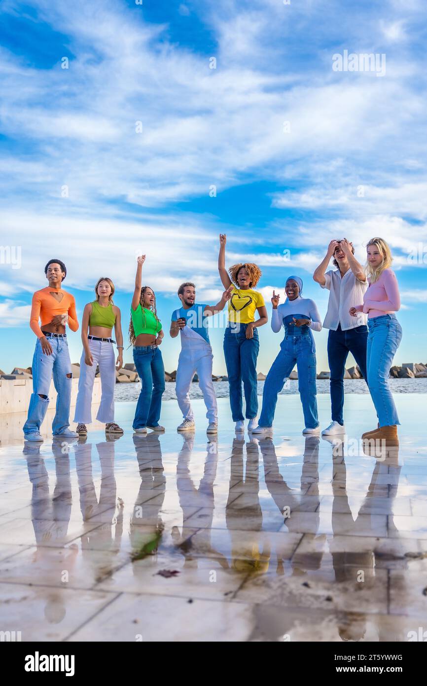 Vertical photo of a multiracial group of spontaneous young people ...