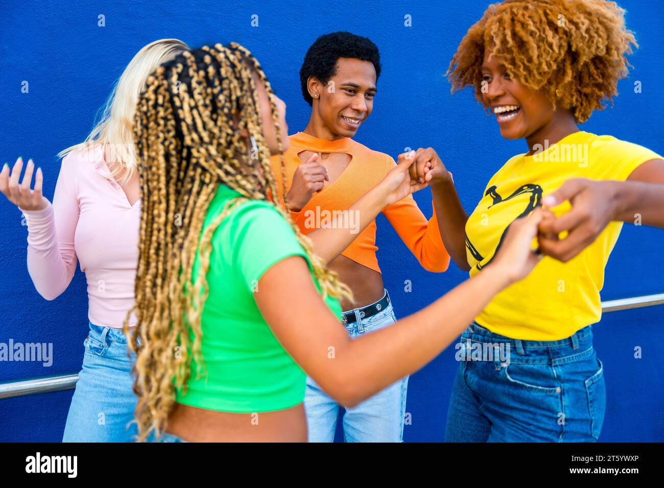 Latin and african american woman dancing salsa together with friends ...