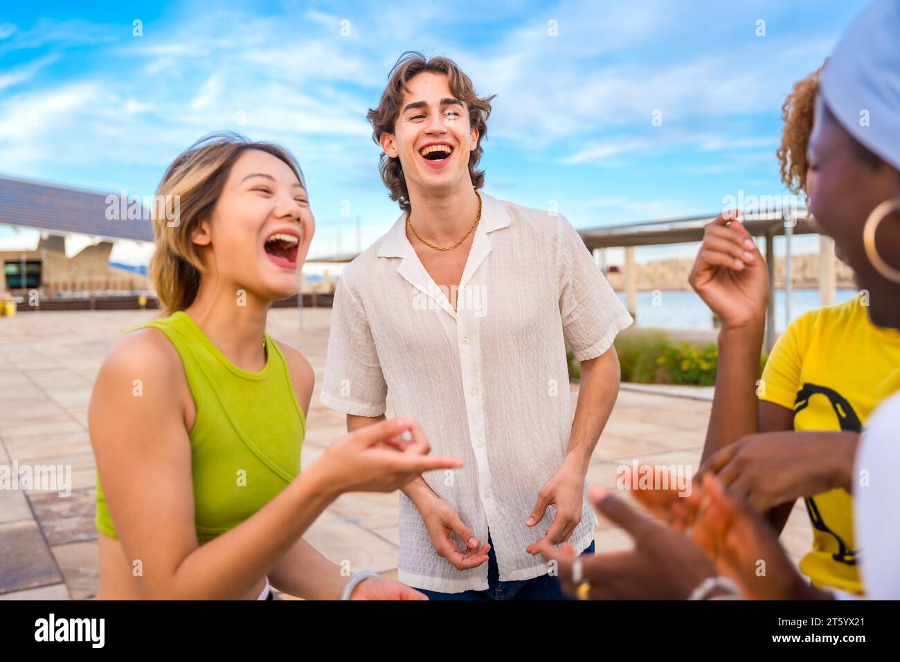 Chinese girl talking to friends in a happy conversation outdoors next ...