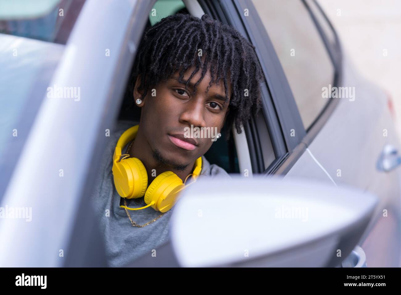 Close-up portrait of a serious african young man inside a car Stock ...
