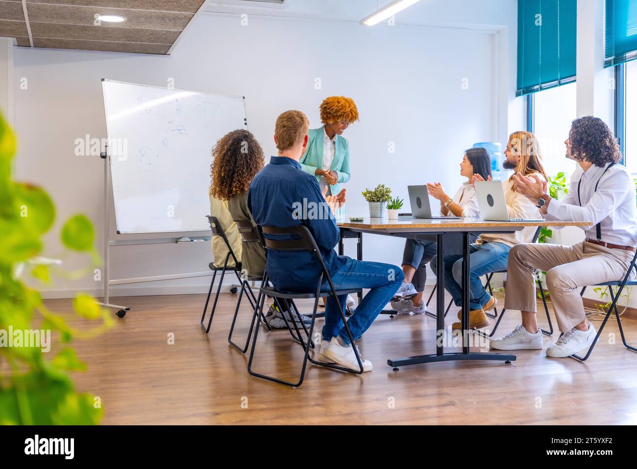 Photo with copy space of a young work team finishing a meeting in a ...