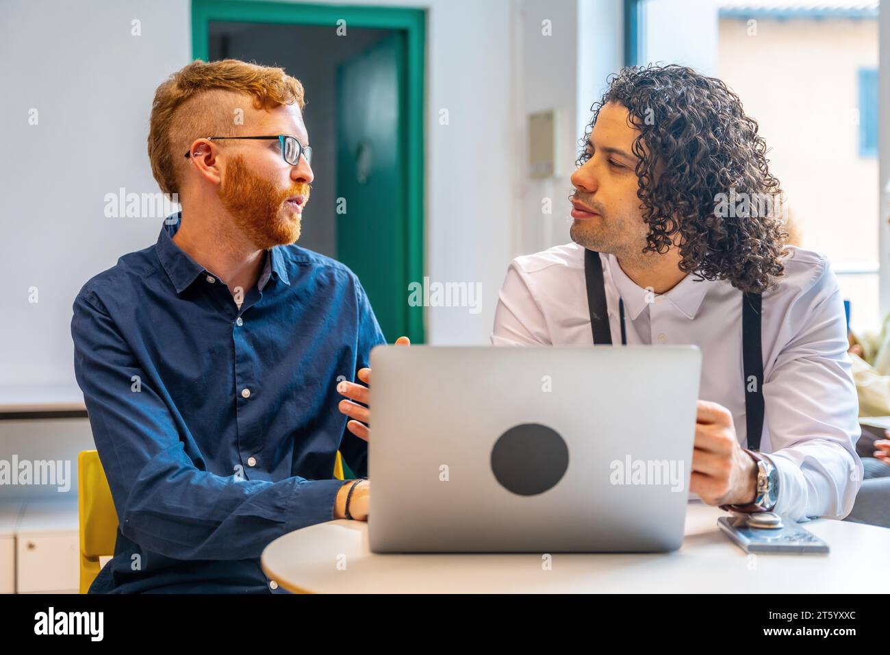 Two positive male female colleagues hi-res stock photography and images ...