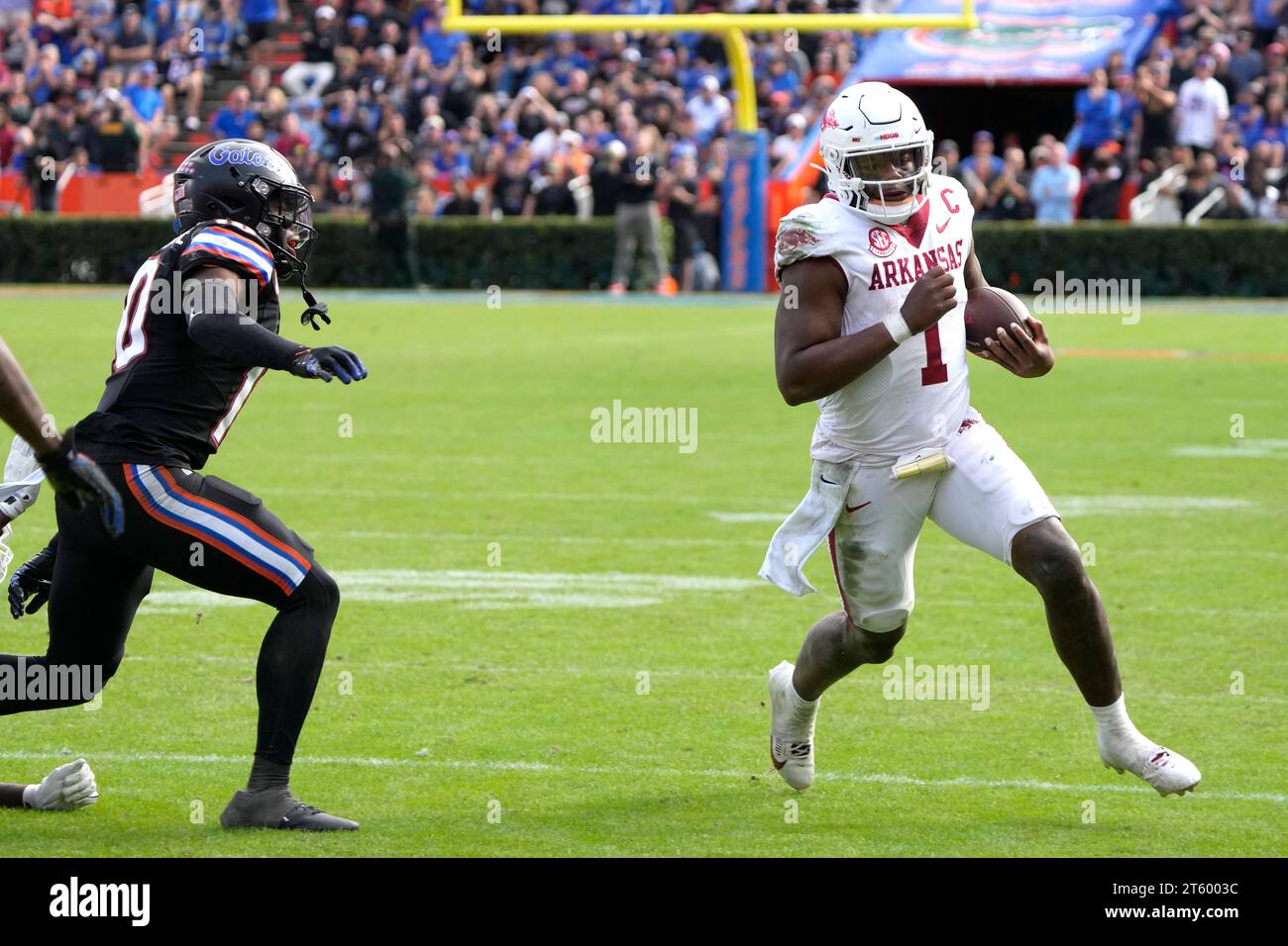 Arkansas quarterback KJ Jefferson (1) runs past Florida safety Miguel ...