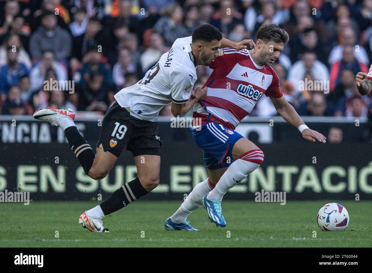 Selim Amallah (Valencia CF) and Lucas Boyé (Granada FC) seen in action ...