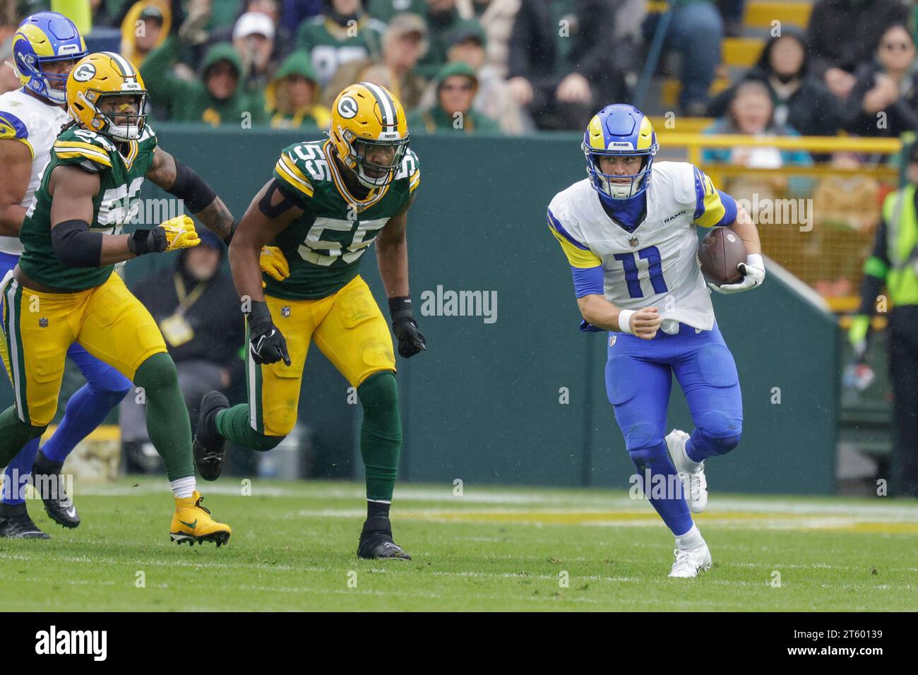 Los Angeles Rams quarterback Brett Rypien (11) is chased out of the pocket by Green Bay Packers ...