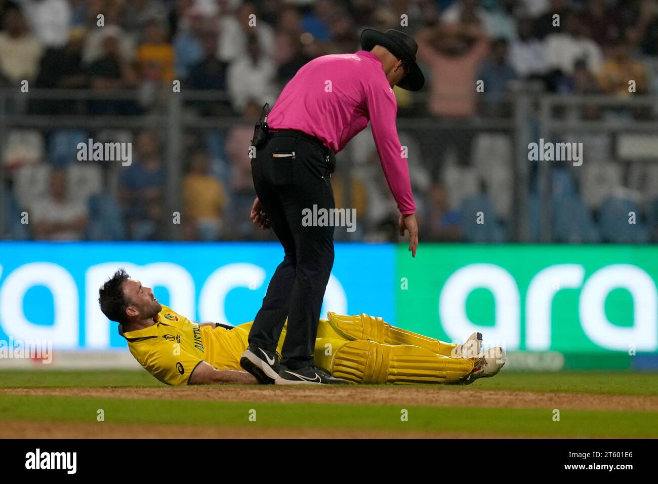 Australia's Glenn Maxwell reacts in pain due to cramps as he lies on ...