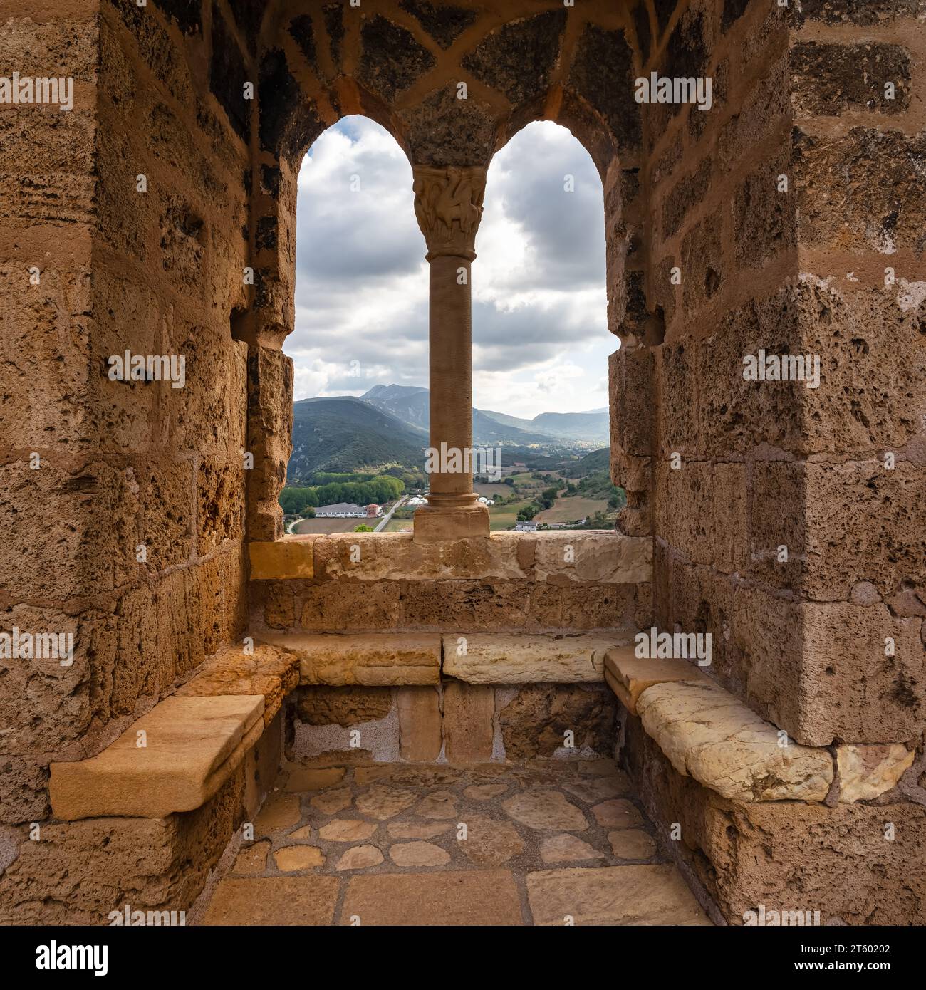 Medieval-style arched window in the wall surrounding the tourist town ...