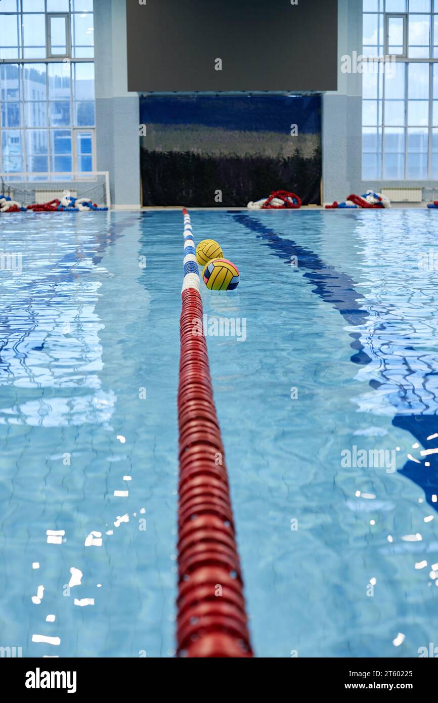 Long red plastic buoy representing finish line on surface of blue water ...