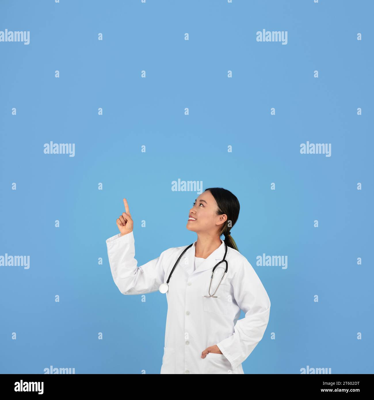 Check This. Smiling Asian Doctor Woman Pointing Up With Finger Stock ...