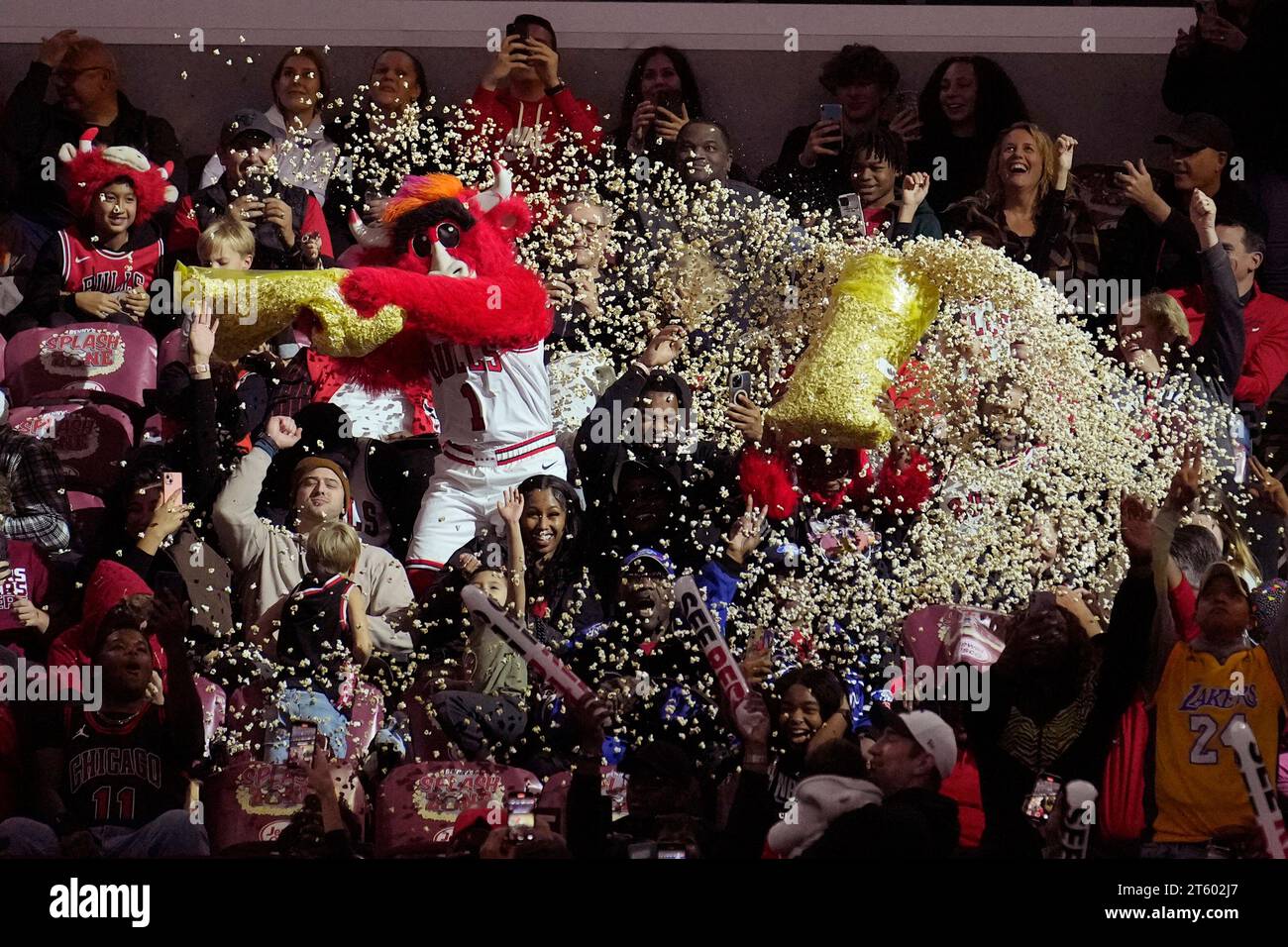 The Chicago Bulls mascot Benny The Bull pours a complete bag of popcorn ...