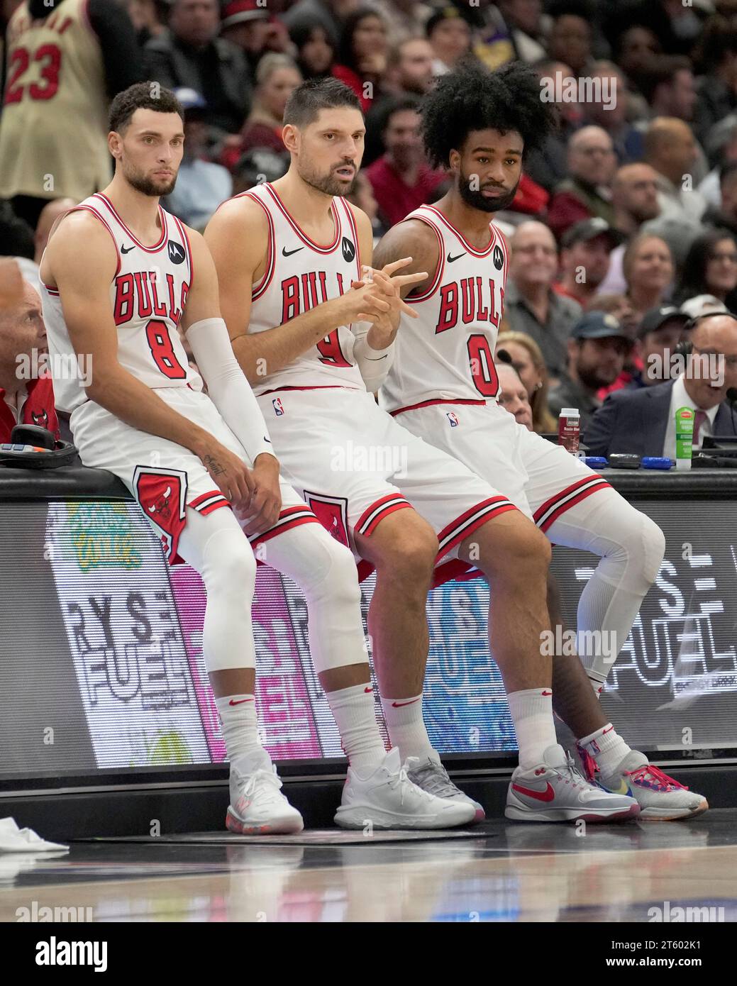 Chicago Bulls' from left, Zach LaVine, Nikola Vucevic, Coby White wait ...