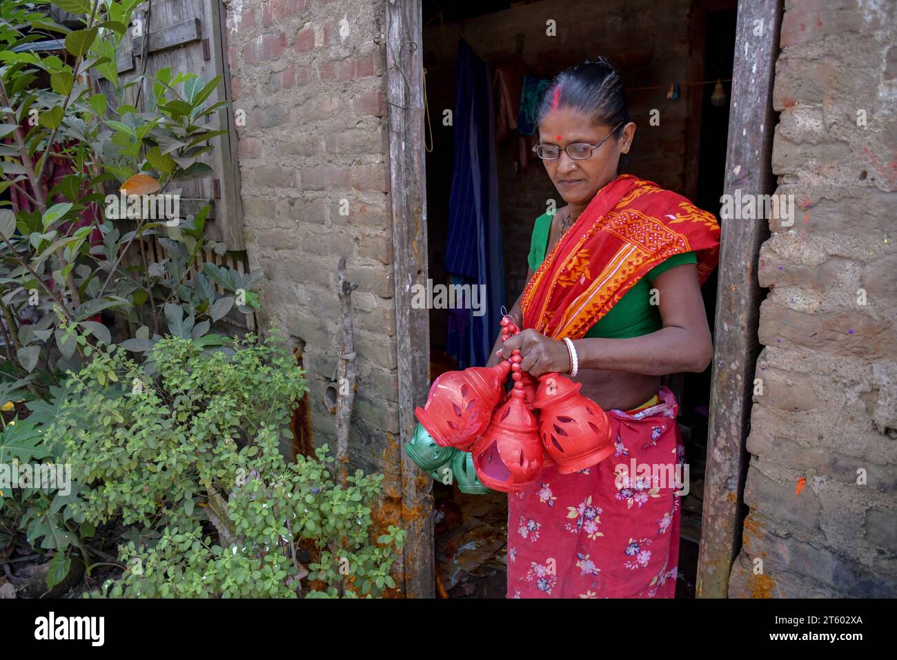 A worker is sorting earthen lamp in the pottery village named ...