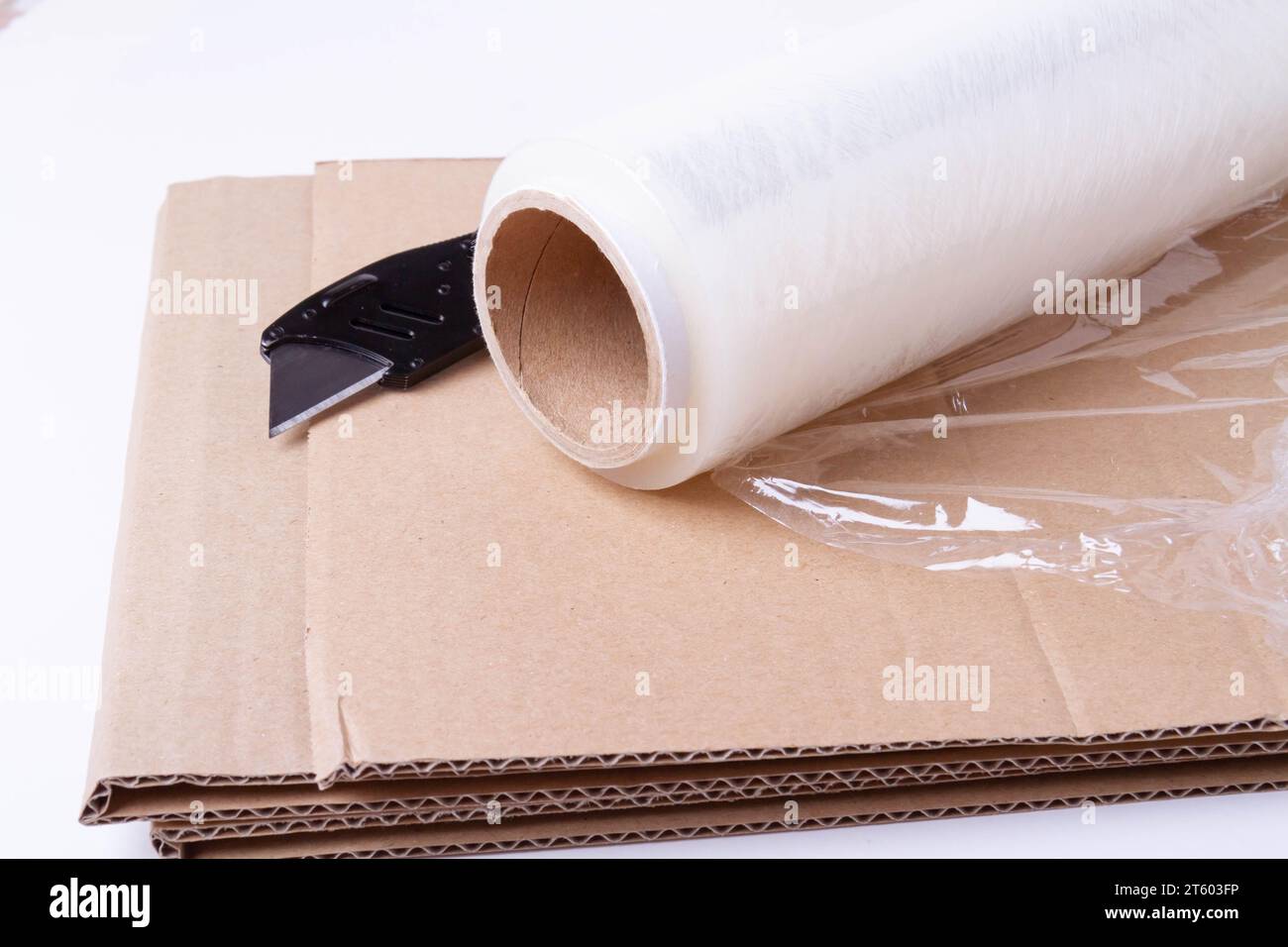 Packing the goods in a cardboard box and stretch film. Tools for ...