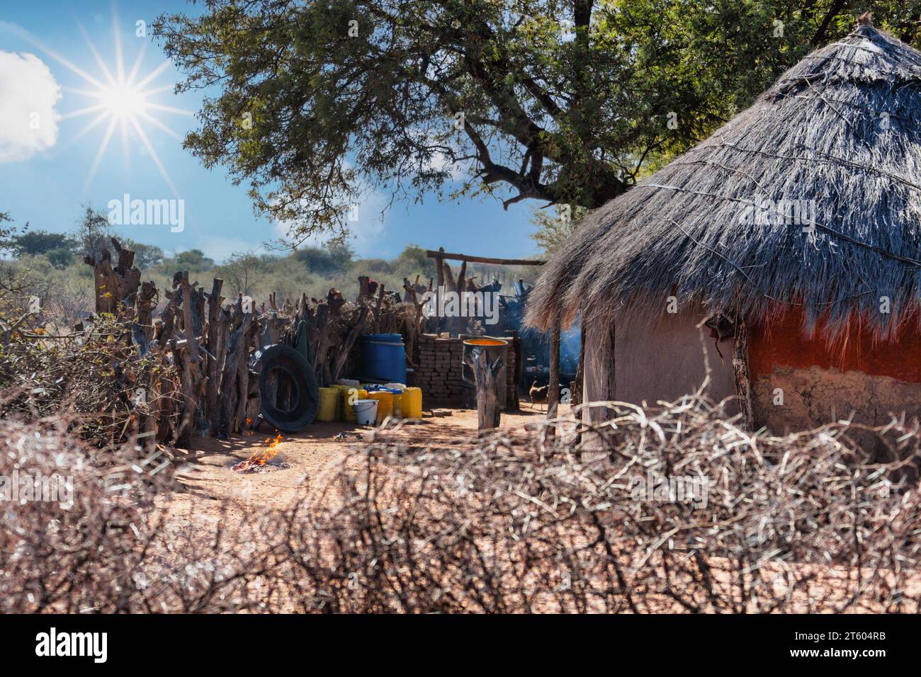 kraal, mud hut with thatched toof, fire burning in the yard, village ...
