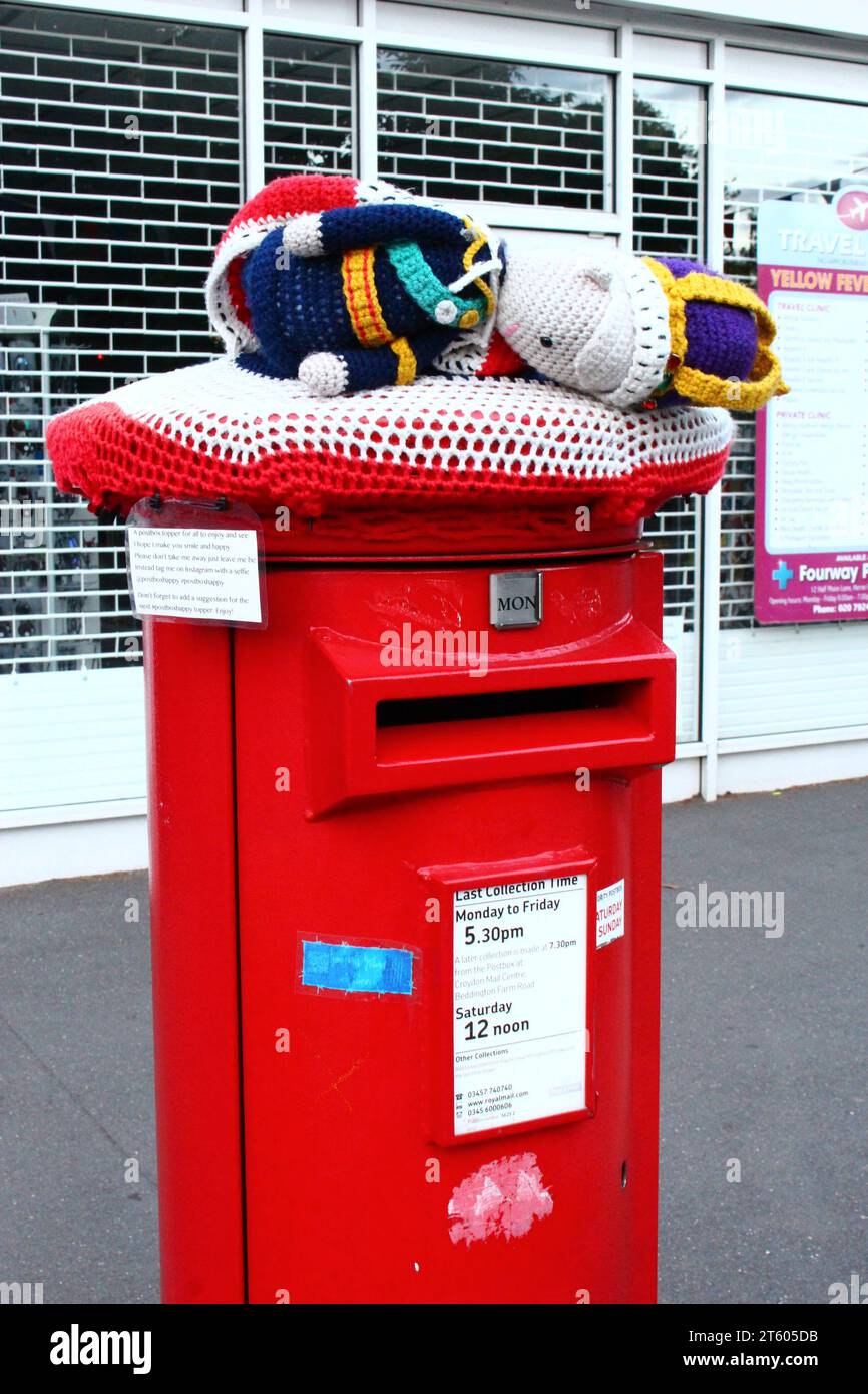 King Charles lll puppet lying down sideways atop a red post box Stock ...