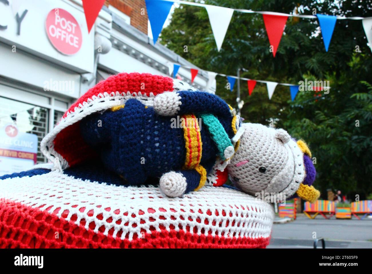 Knitted King Charles lll or King Charles III lying down atop post box ...
