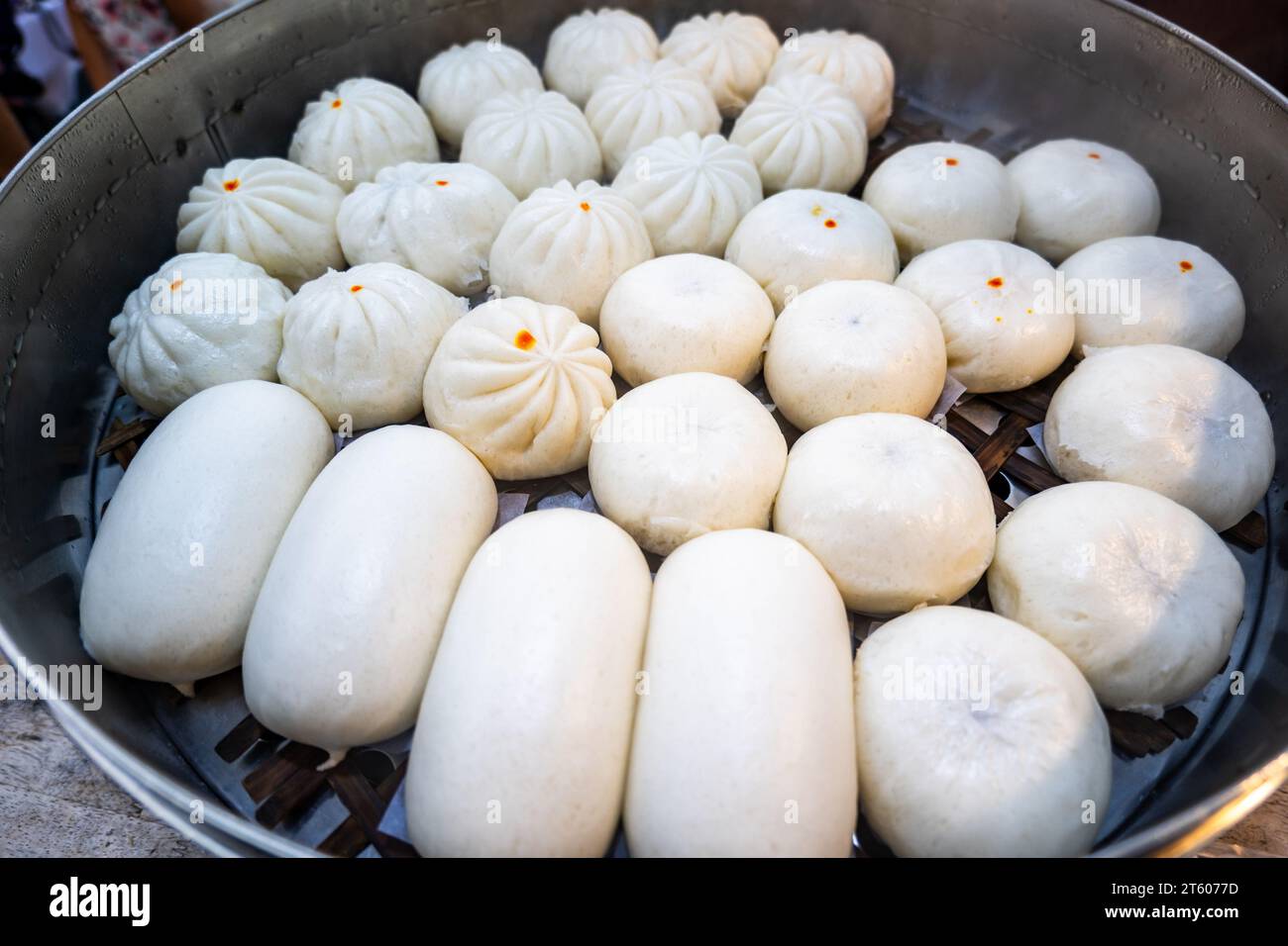 Chinese steamed buns in the steam pot displayed at the stall. Popular ...