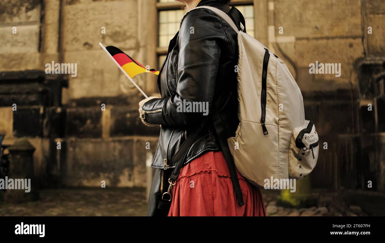 Attractive Female Tourist With Germany Flag Walks In Historical Center ...