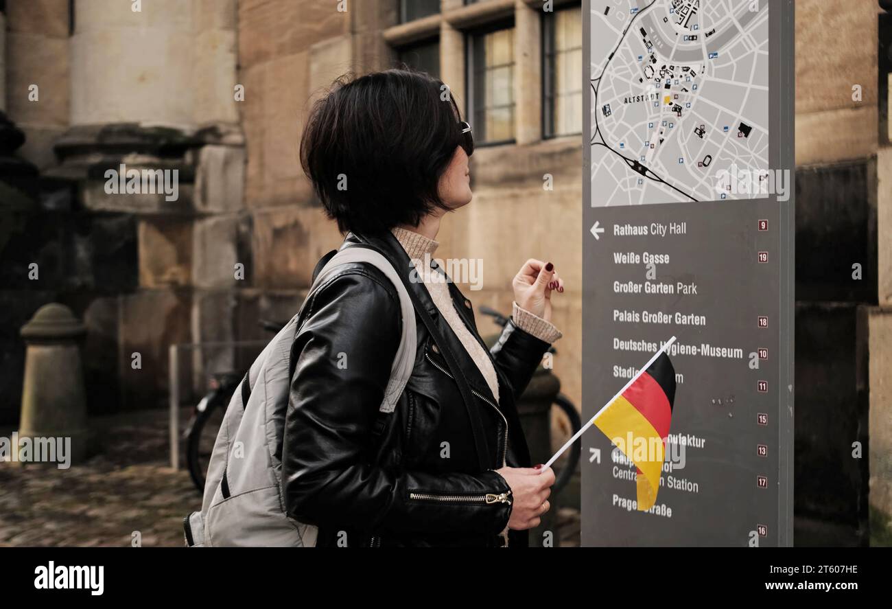 Attractive Female Tourist Walks With Germany Flag In Historical Center ...