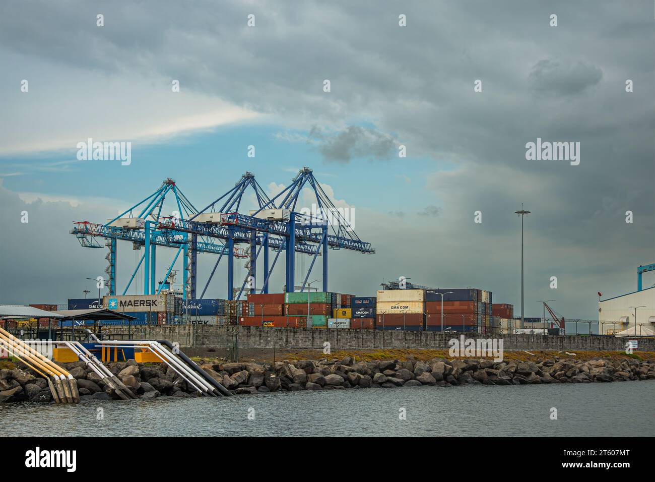 Guatemala, Puerto Quetzal - July 20, 2023: Evening sky over 3 cranes ...
