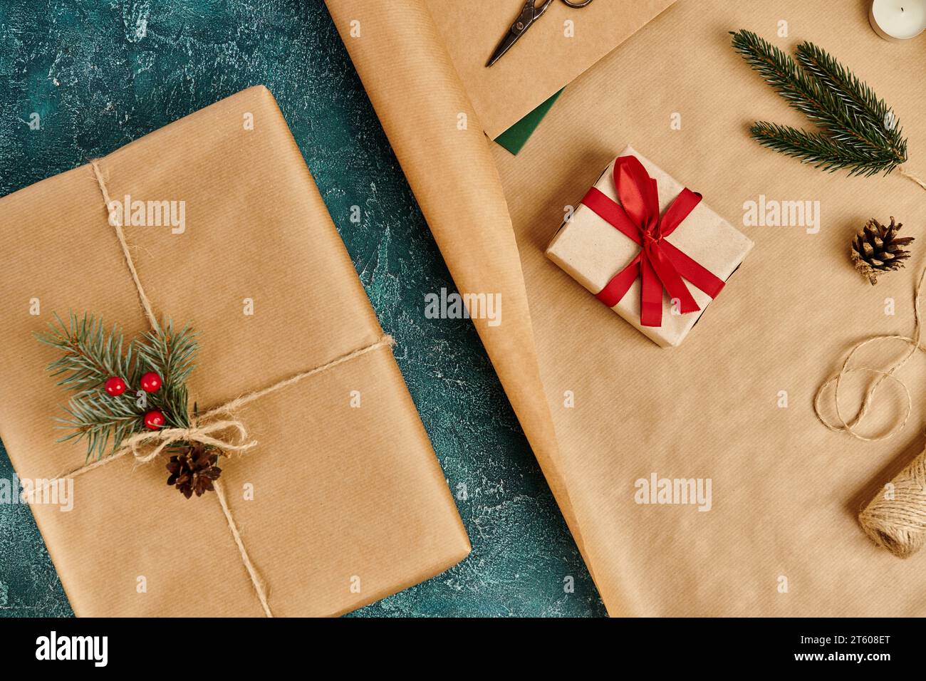 present boxes and pine decor with twine on wrapping paper on blue ...