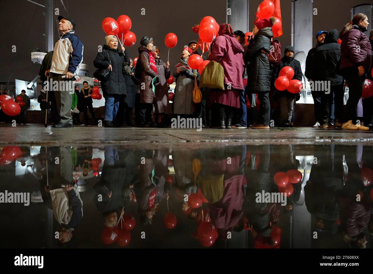 Communist party supporters sing as they gather near the Aurora Cruiser ...