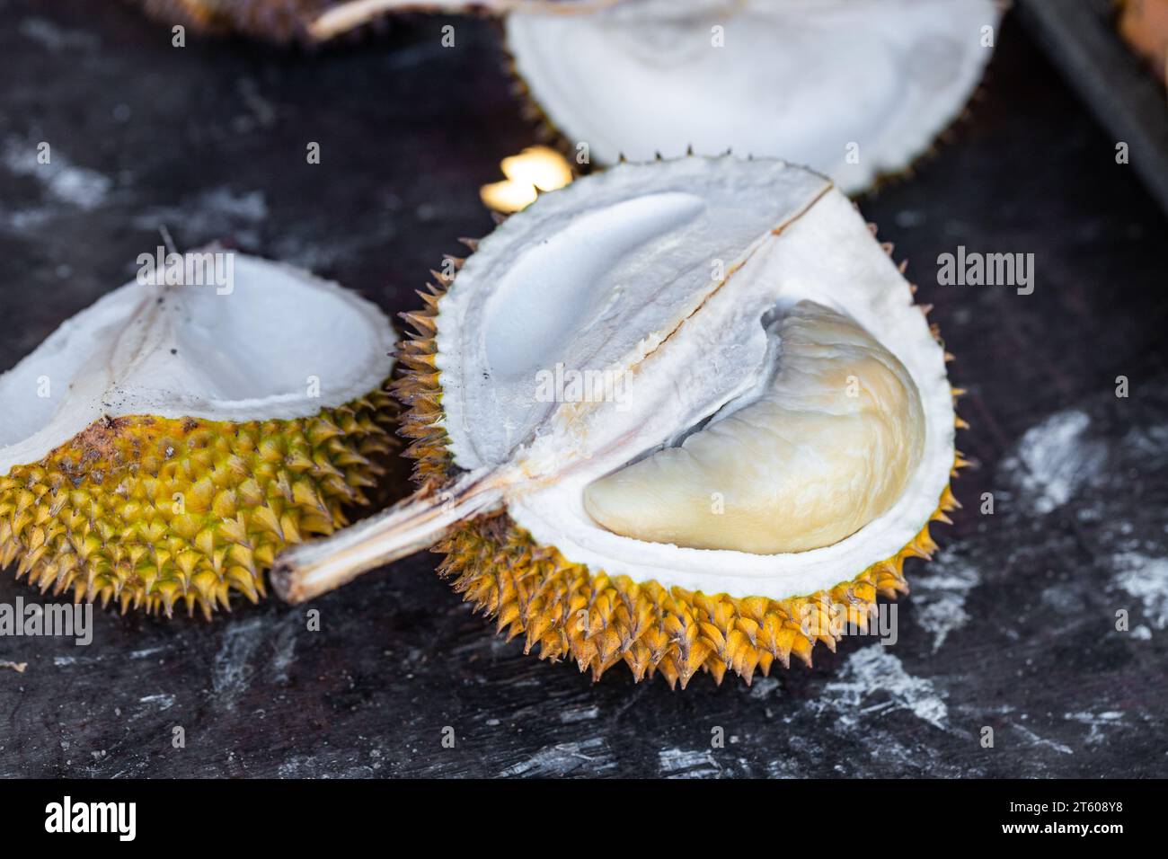 Durian fruit cut in half, a smelly fruit, a specific fruit from Asia ...