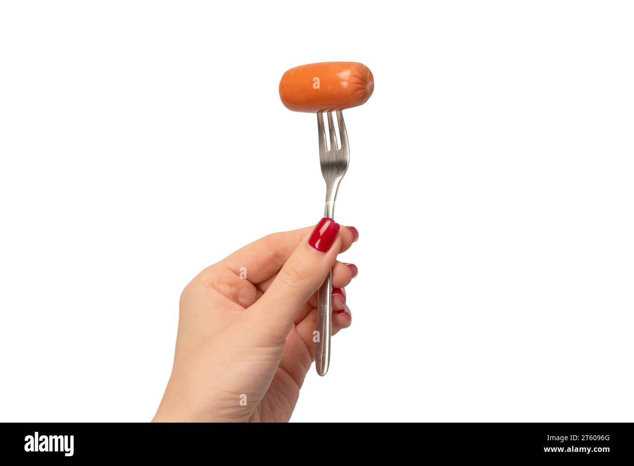 Small sausage on a fork in woman hand isolated on a white background ...