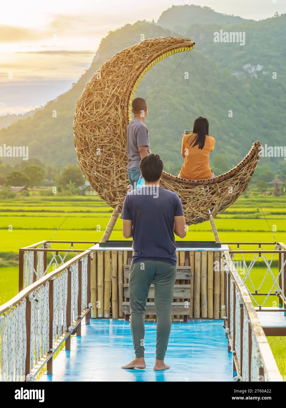 Man using camera to take photo with happiness young couple on crescent ...