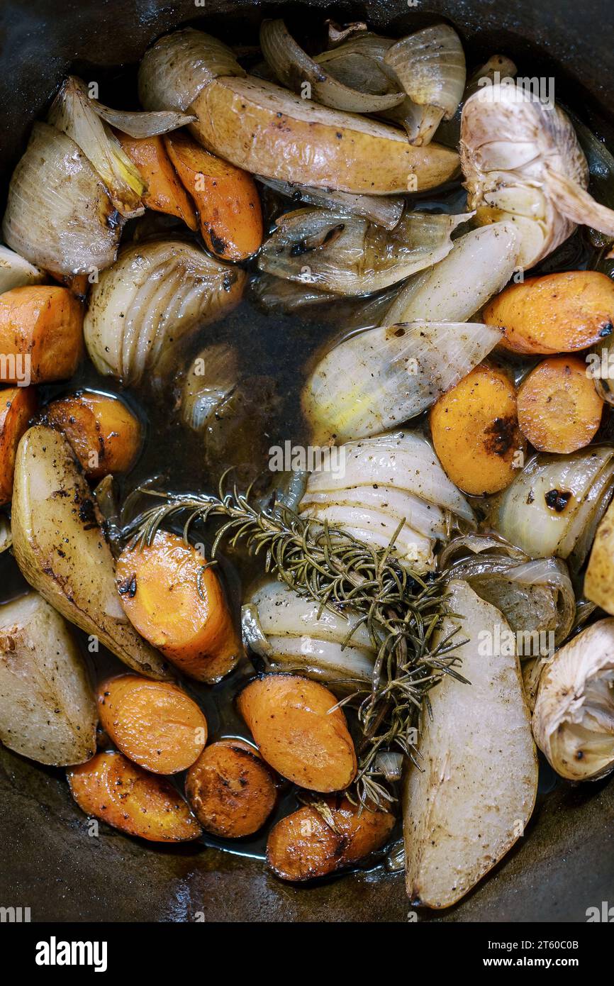 Pieces of fresh vegetables with spices are stewed in oil in a frying ...