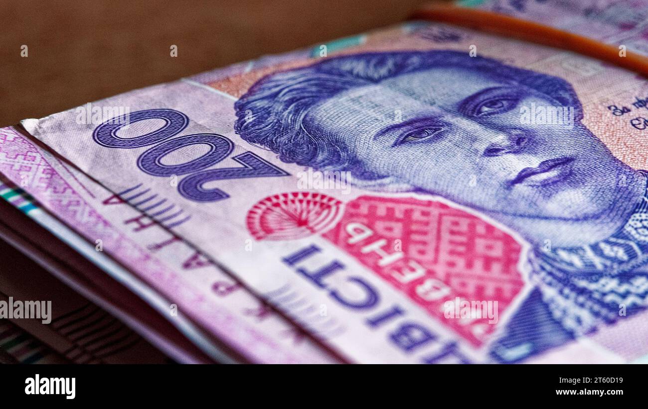 An organized stack of Ukrainian hryvnia banknotes, carefully fastened ...
