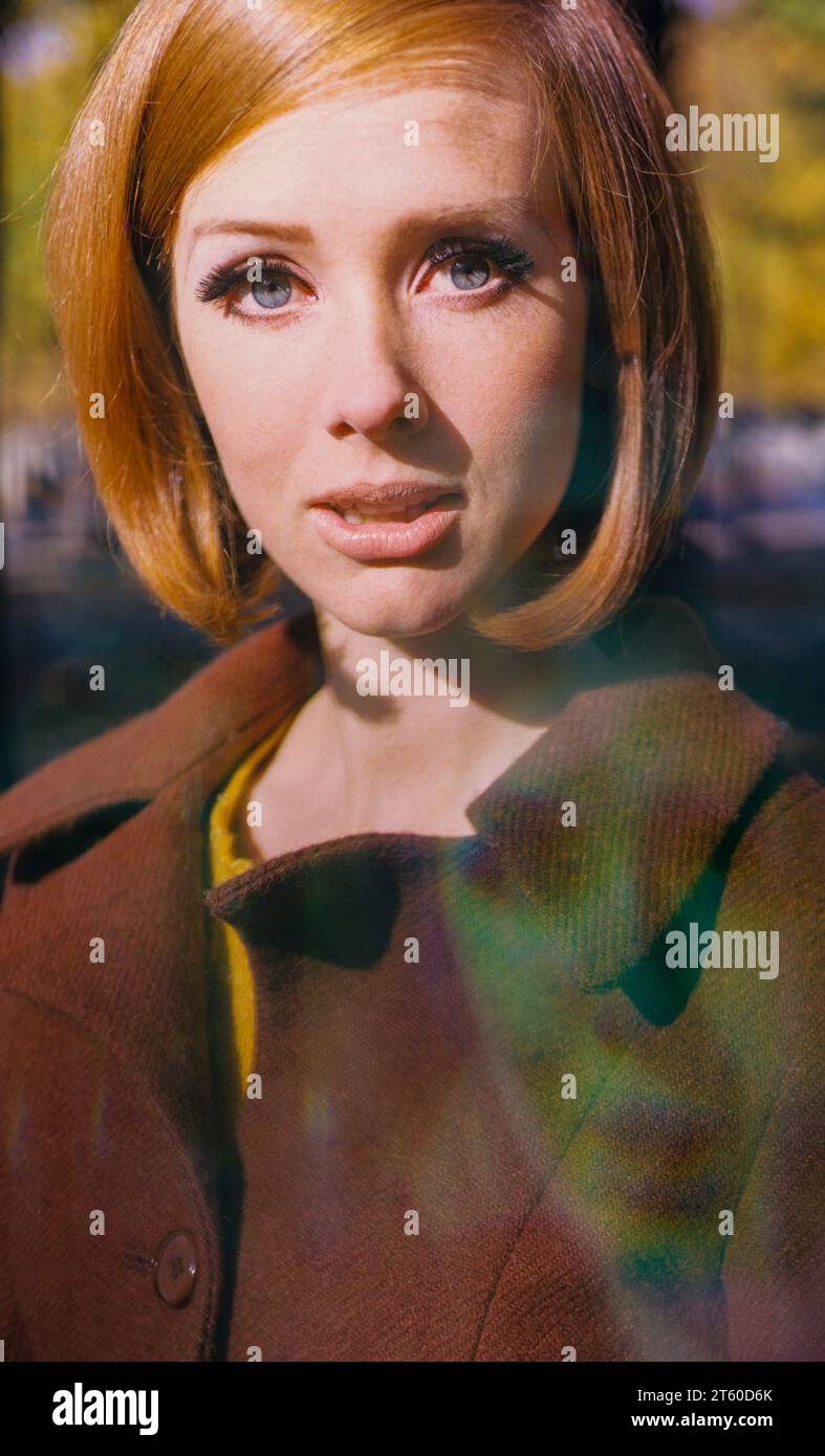 1960s, red haired woman fashion model looking to camera portrait, green ...