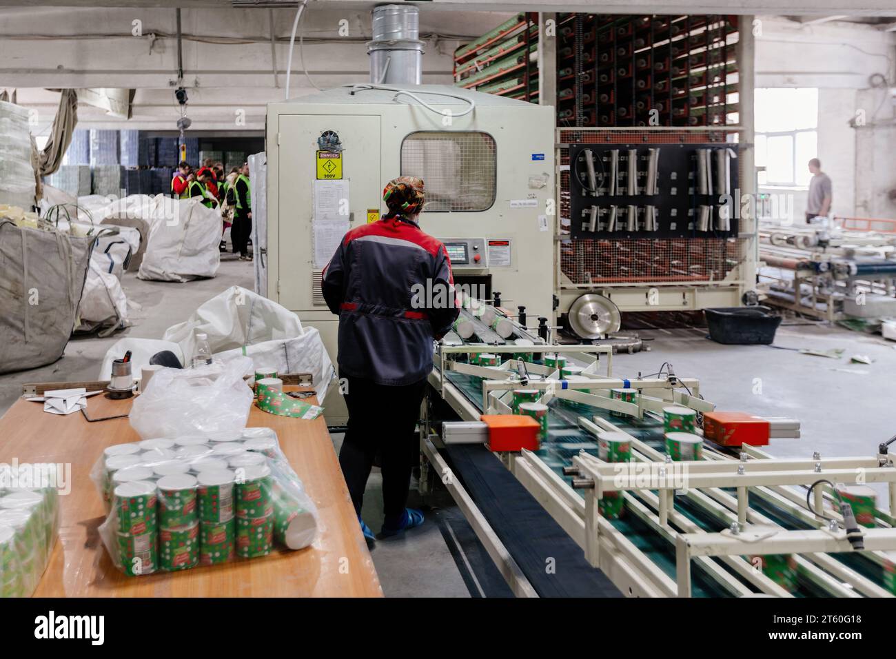 Toilet paper production line. Worker with conveyor Stock Photo - Alamy
