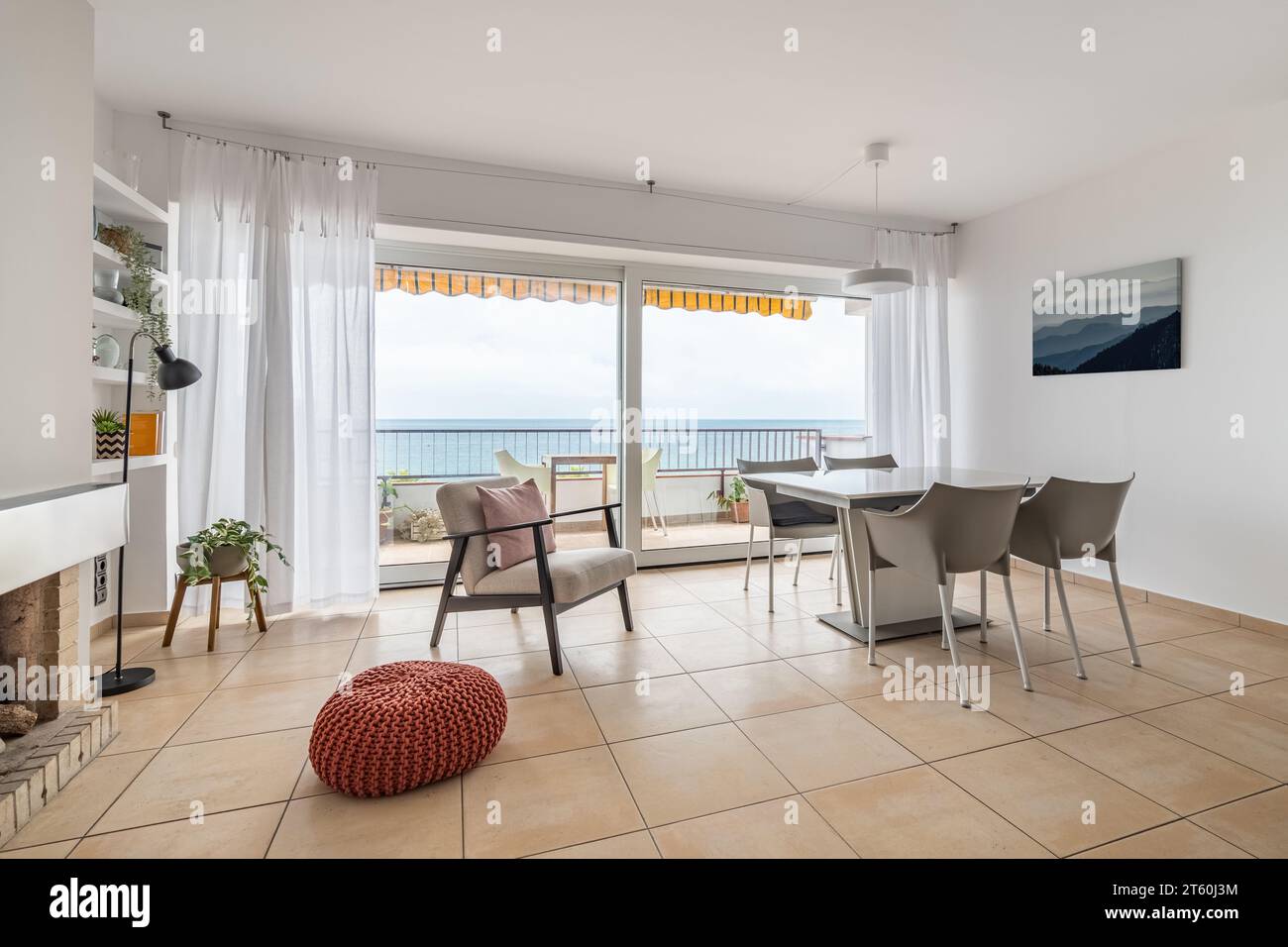 Dining table with chairs near terrace with panoramic window Stock Photo ...