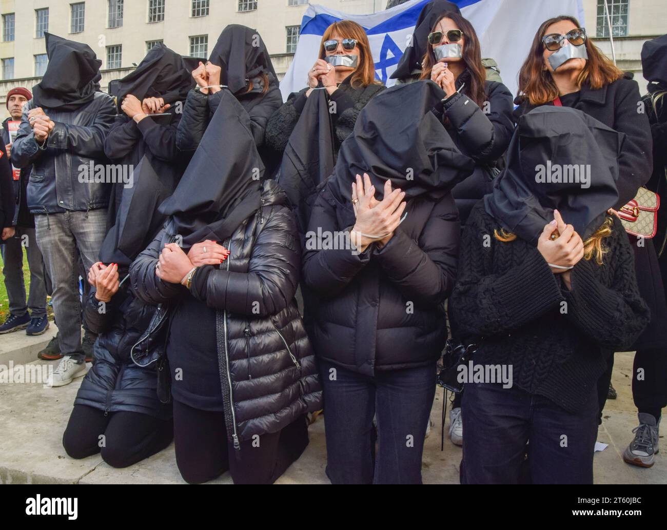 London, UK. 07th Nov, 2023. Protesters have their hands tied, mouths ...