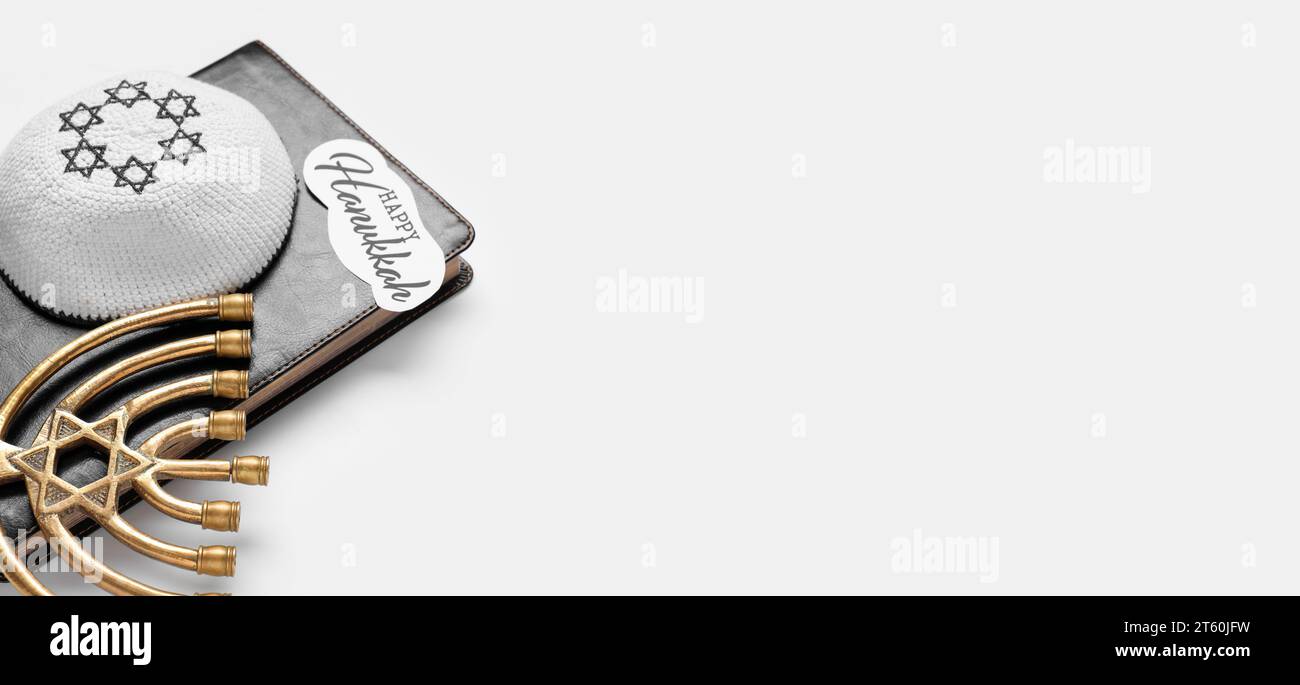 Torah, menorah and kippah on light background with space for text ...