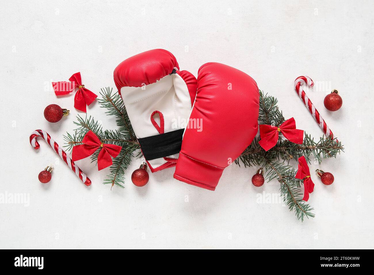 Boxing gloves with Christmas tree branches, balls and candy canes on ...
