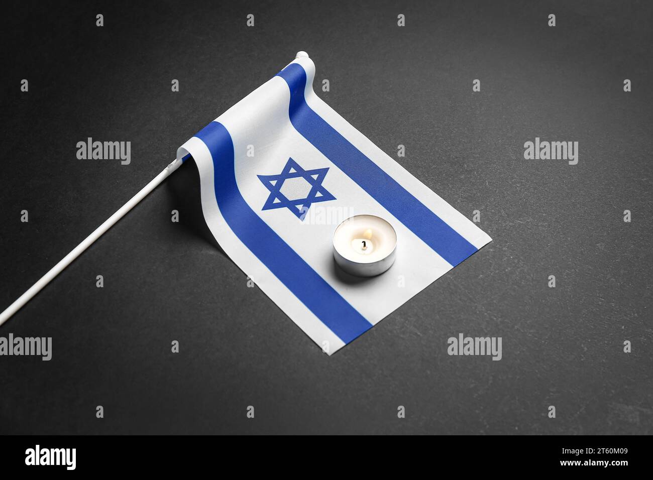 Flag of Israel with burning candle on dark background Stock Photo - Alamy