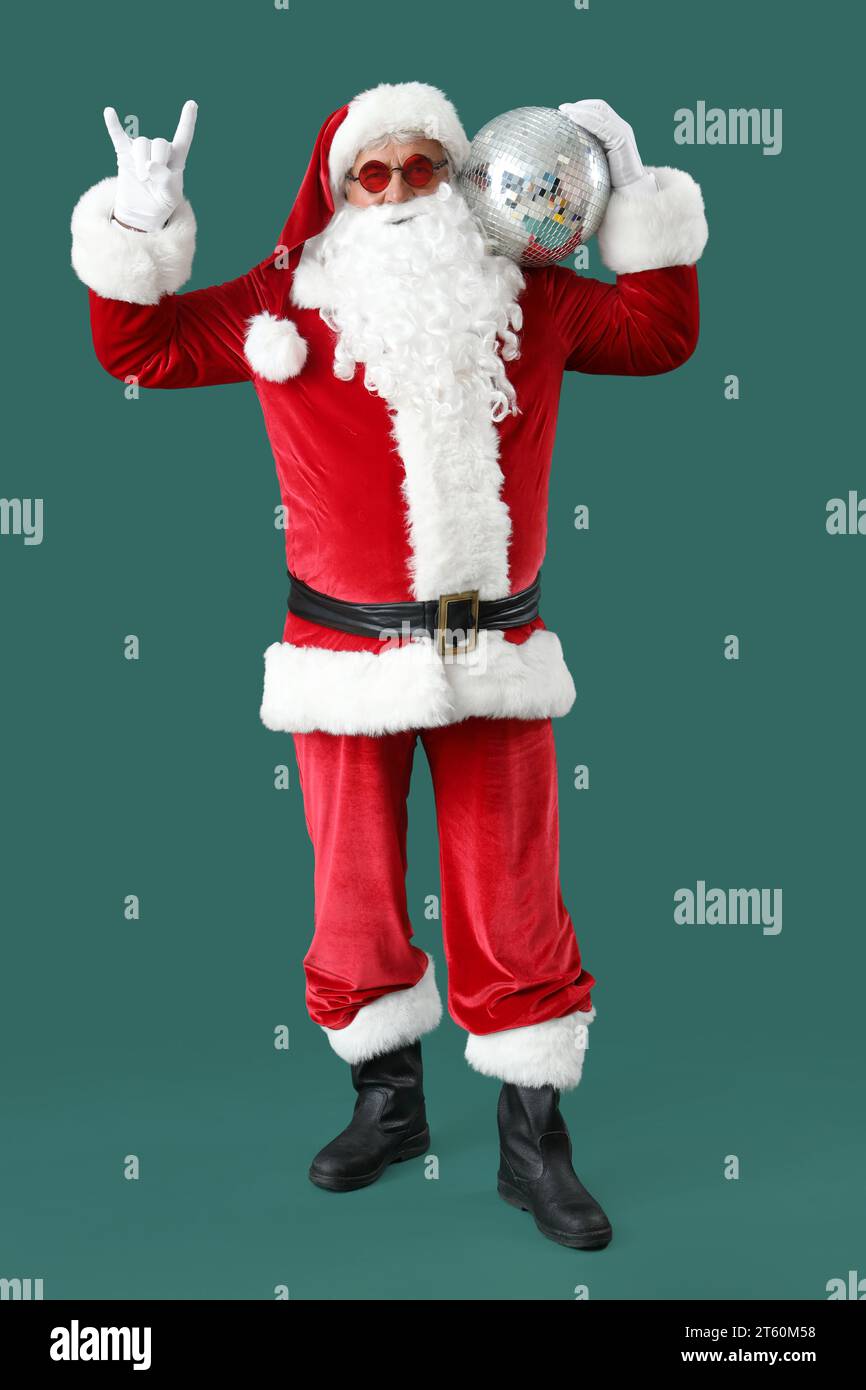 Cool Santa Claus with disco ball showing "devil horns" on green ...