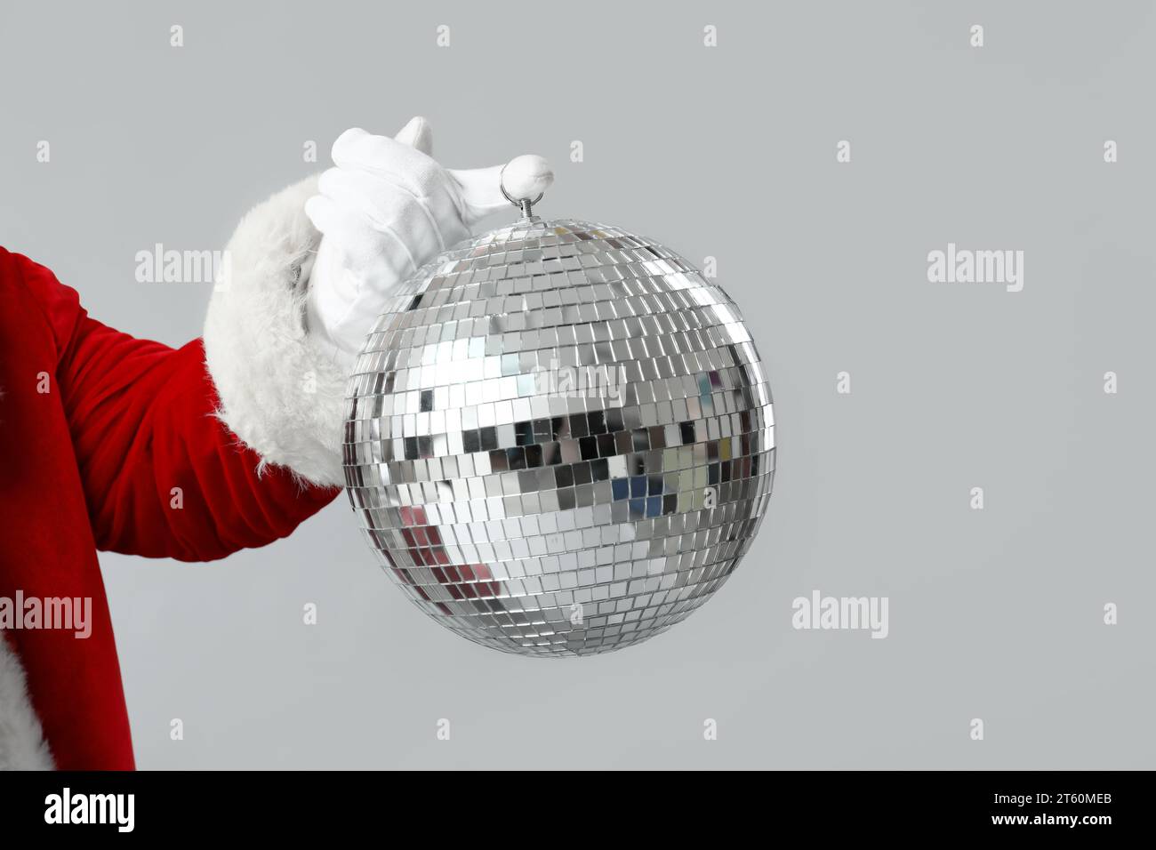 Santa Claus with disco ball on grey background Stock Photo - Alamy