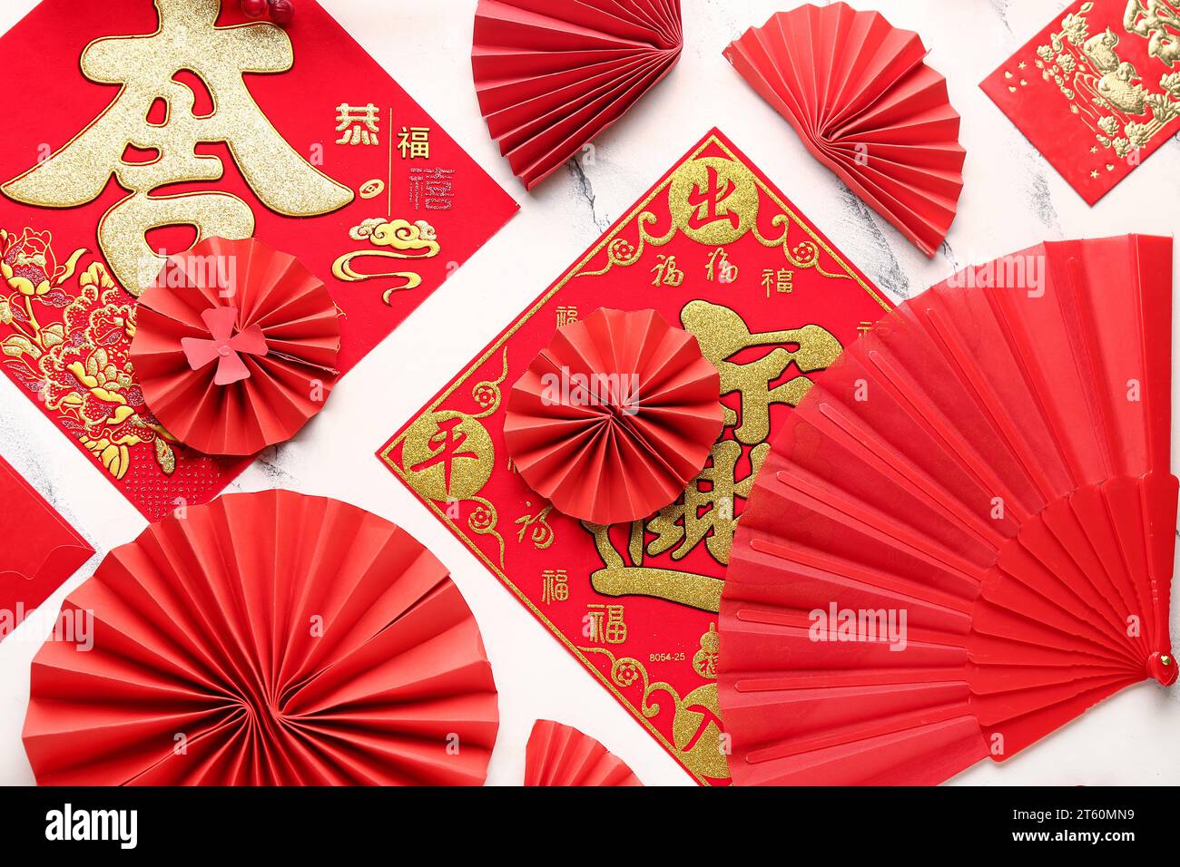 Traditional napkins with red envelope, fans and Chinese symbols on ...