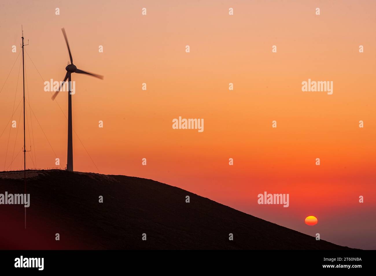 A wind turbine, part of a windfarm, harnesses the wind to create energy ...